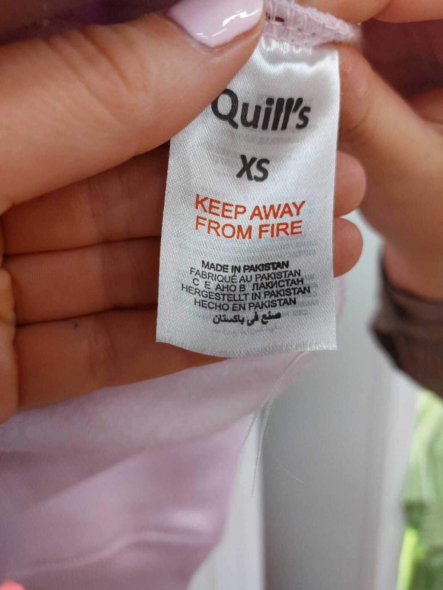 Iconic Kerry chain Quill’s cut off clothing labels with scissors to ...