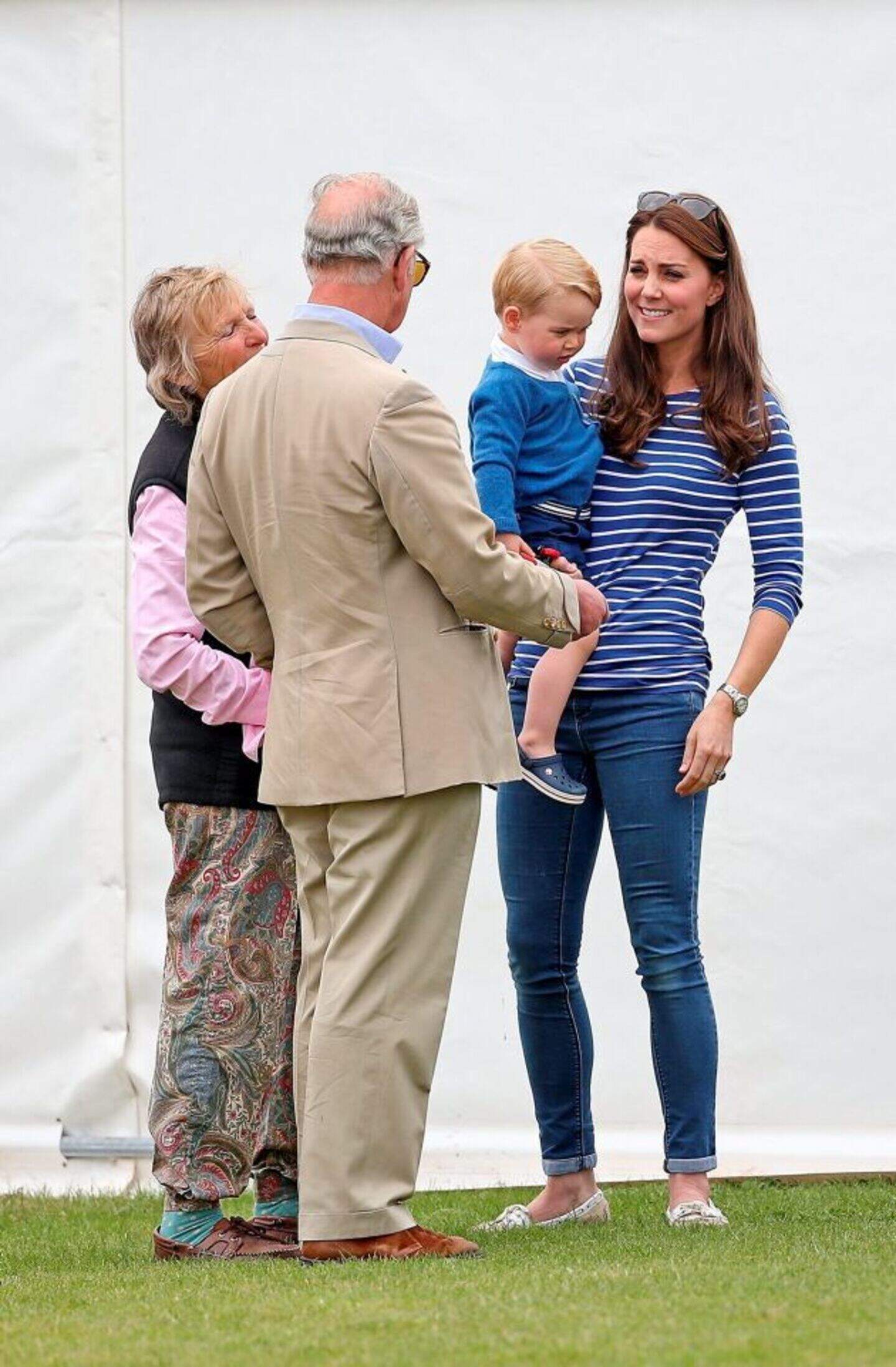 Prince George clambers away from his mum Kate Middleton as they watch ...