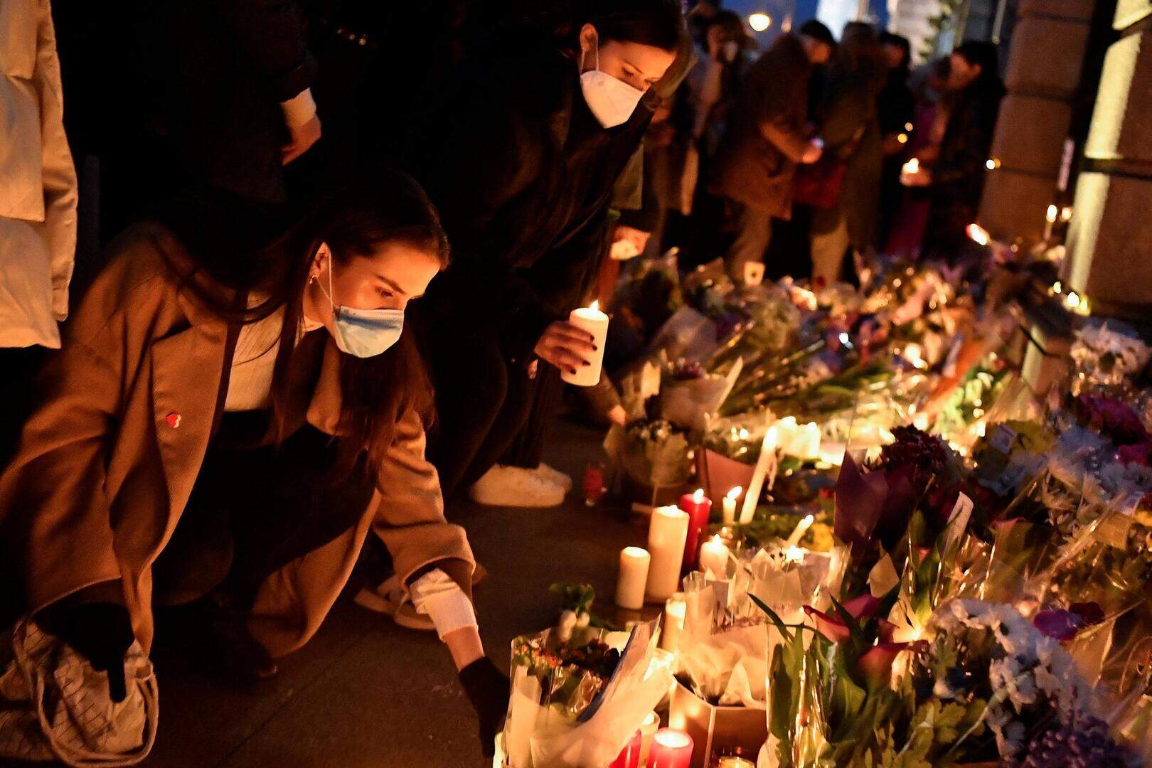 Among a sea of flickering candles, hundreds of voices sang a soft ...