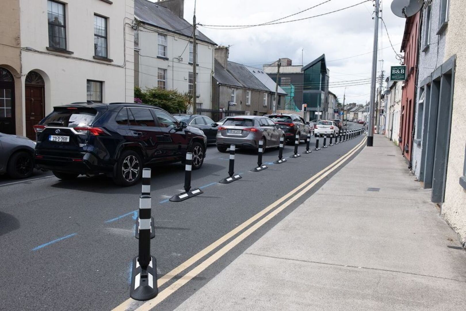Bollard installed in front of wall in Cork town to protect cars from ...