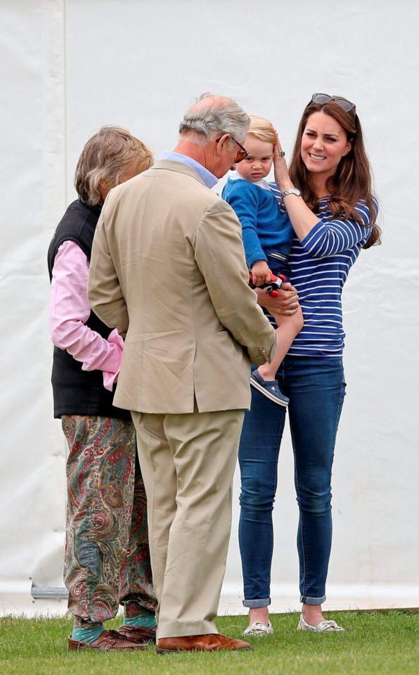 Prince George clambers away from his mum Kate Middleton as they watch ...