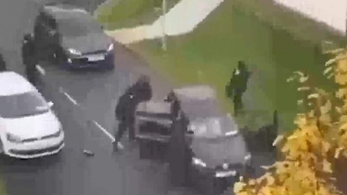 Six people dressed in all black beating a man near the grounds of ...