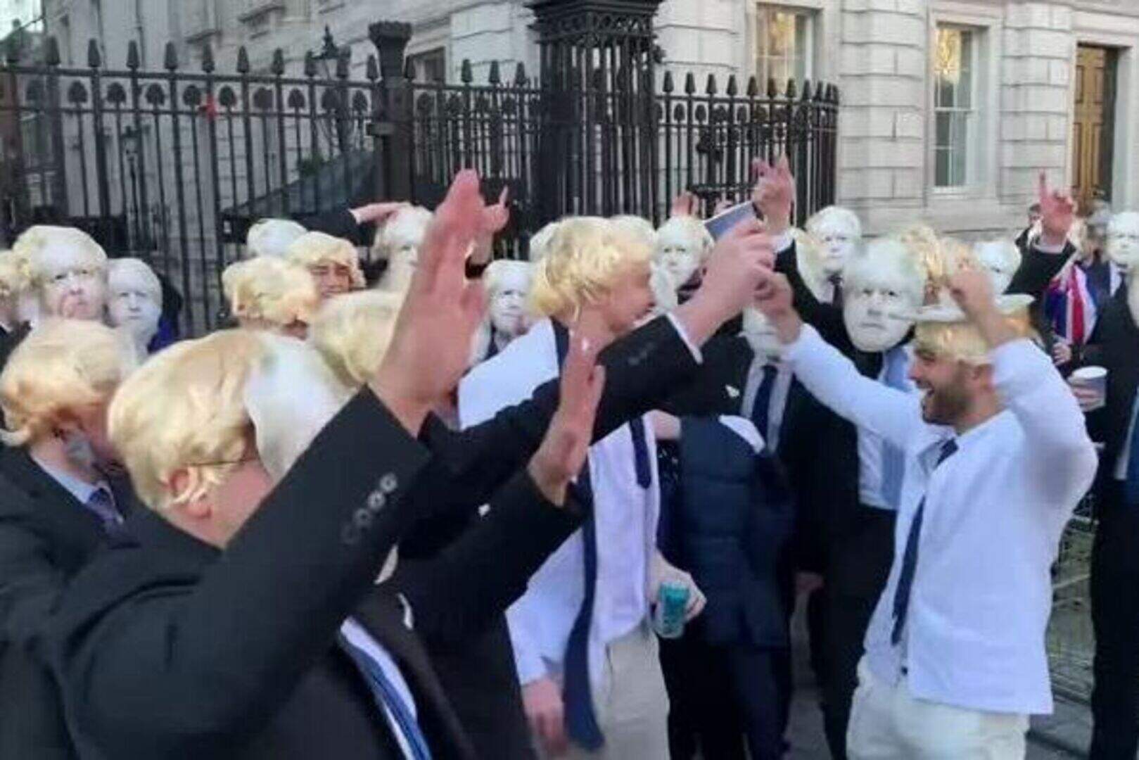 Group of Boris Johnson 'look-a-likes' hold party outside Downing Street ...